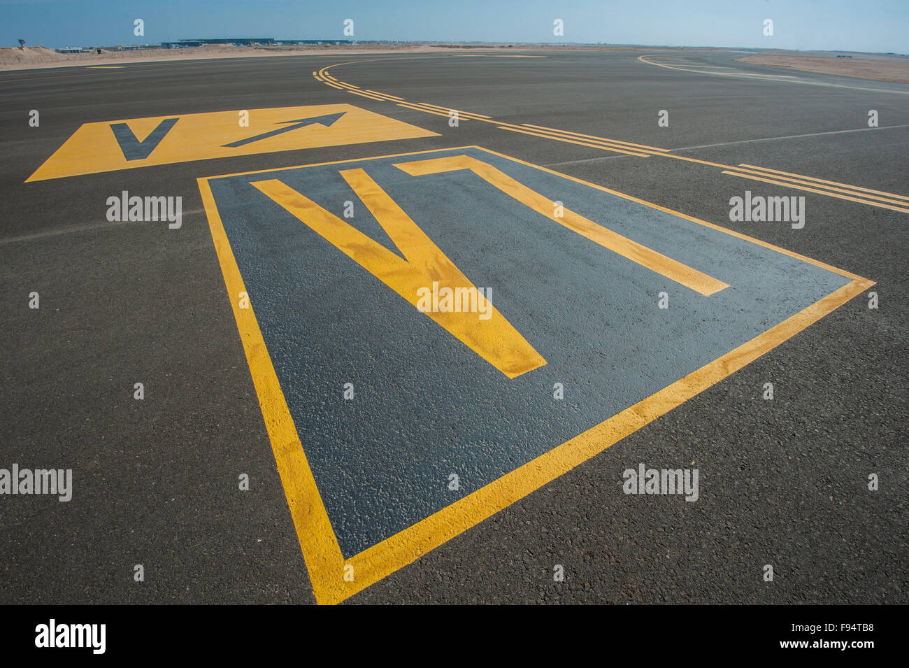 Directional sign markings on the tarmac of runway at a commercial ...