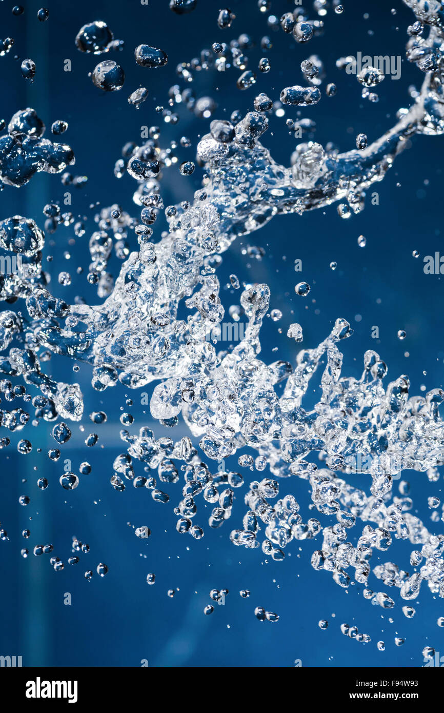 Waterdrops levitating in the air on blue Stock Photo - Alamy