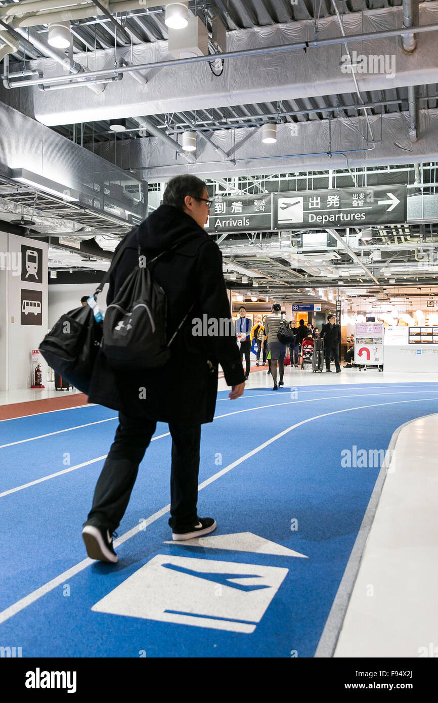 A passenger walks on a running track in the new Terminal 3 at Narita ...