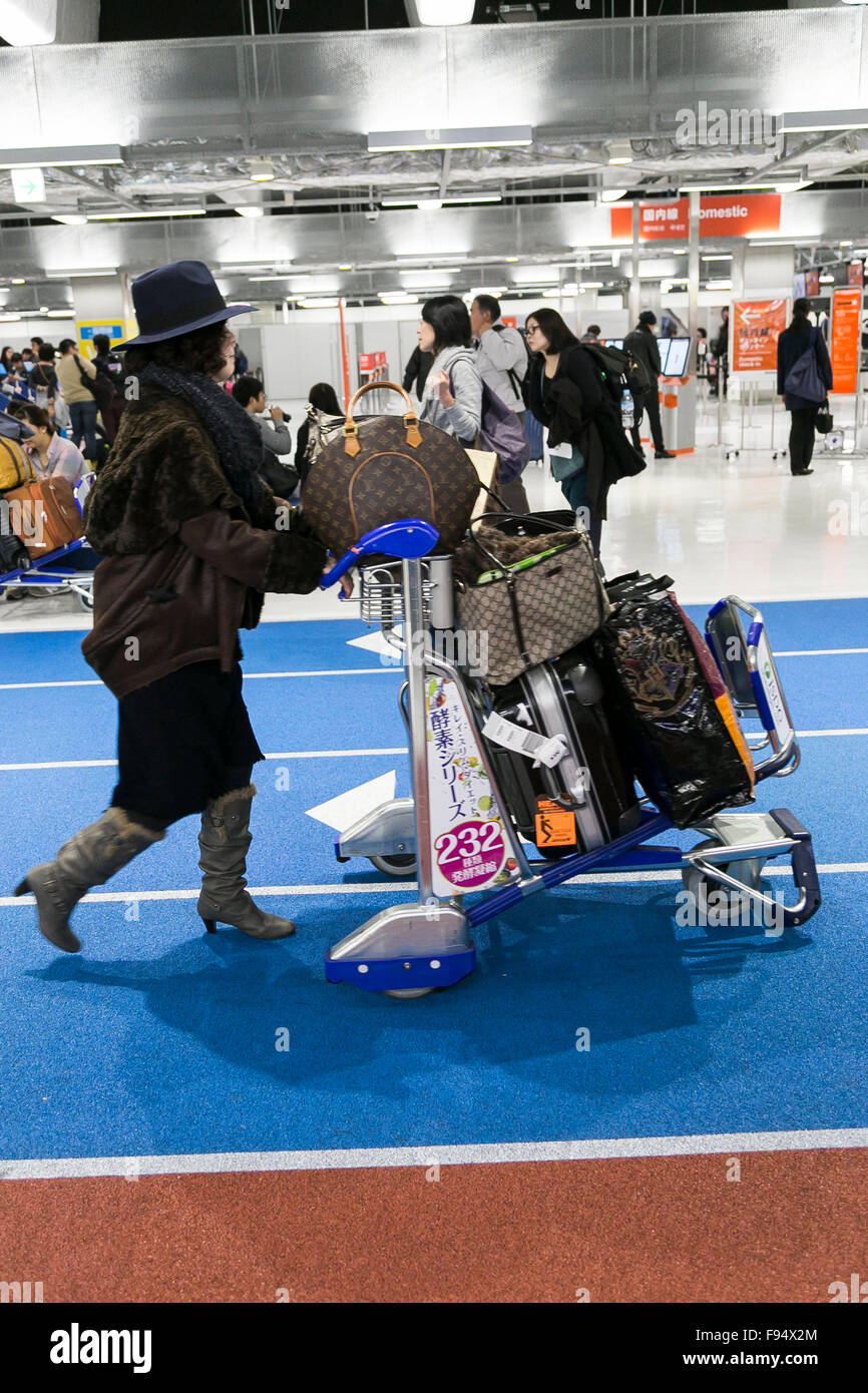 A passenger walks on a running track in the new Terminal 3 at Narita ...