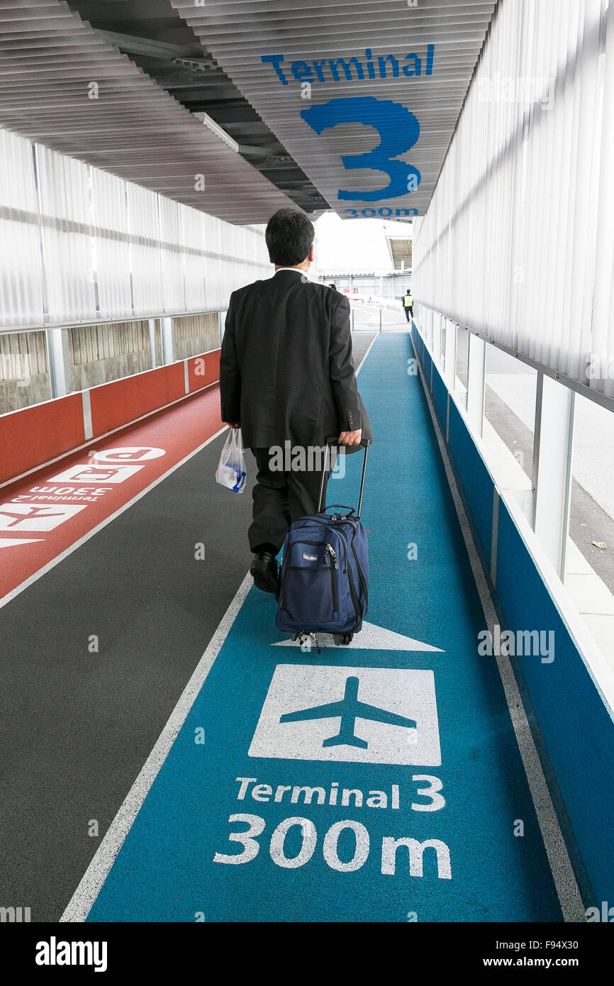 A passenger walks on a running track to the new Terminal 3 at Narita ...