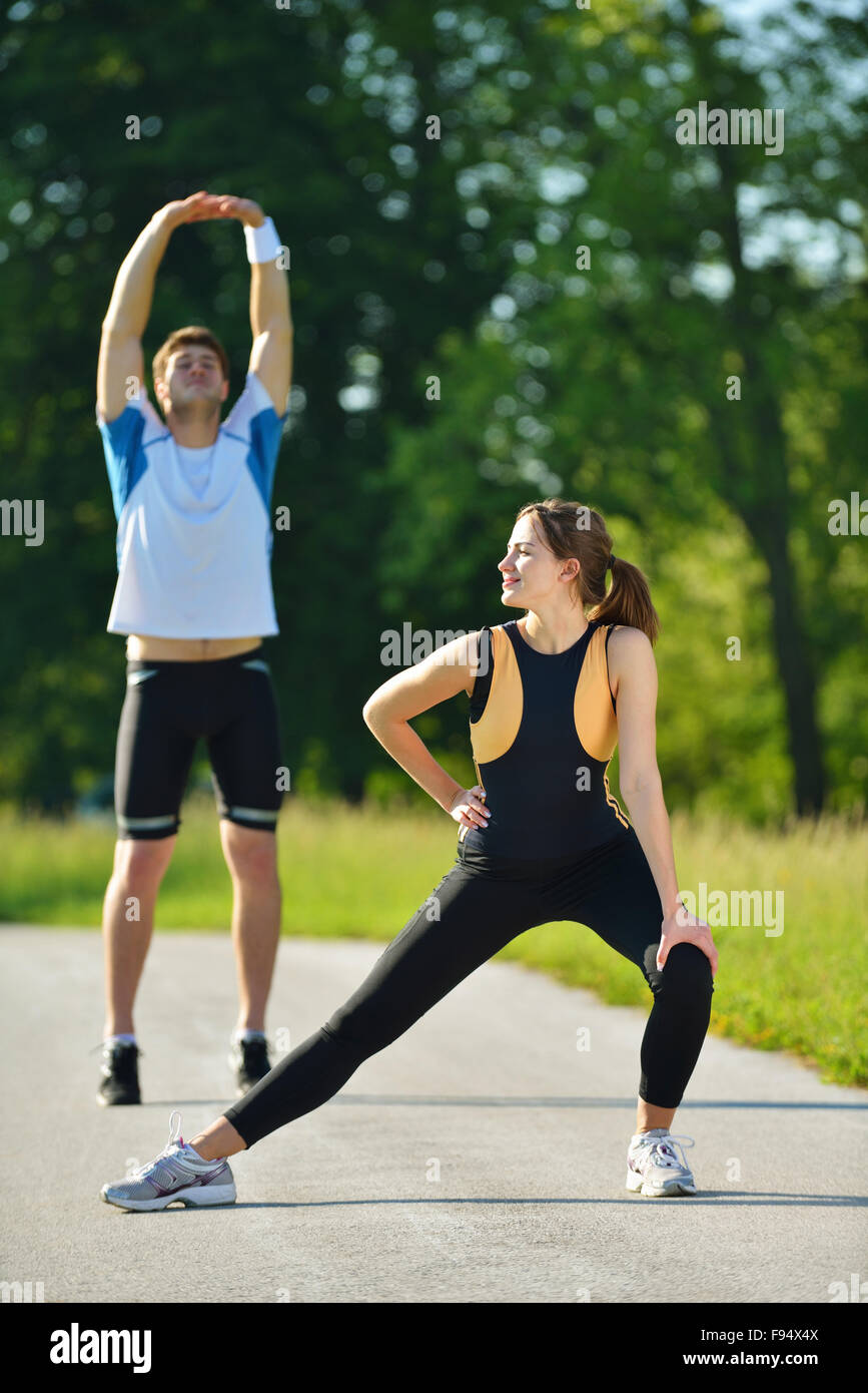 young health couple doing stretching exercise relaxing and warm up ...