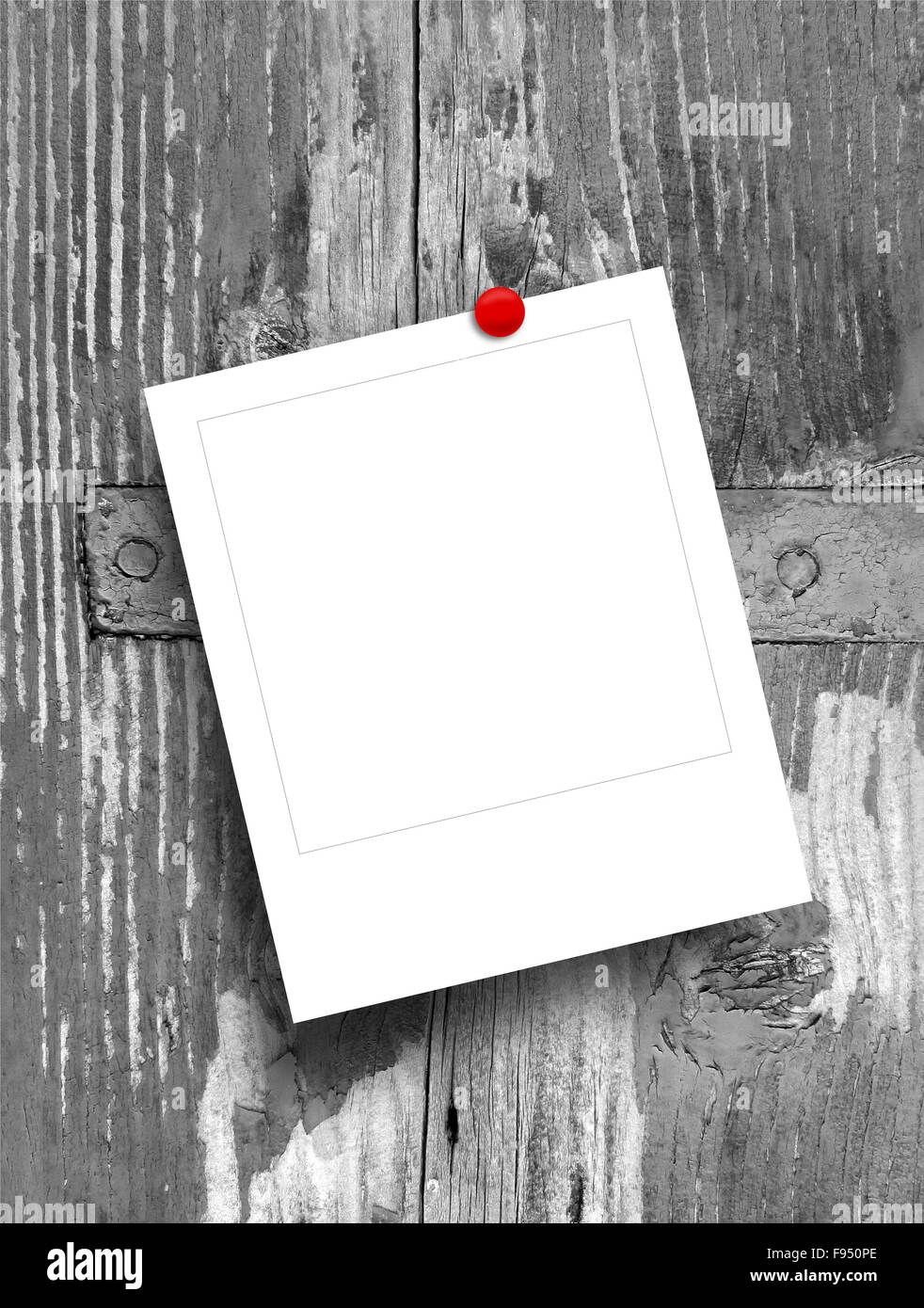 One blank square instant photo frame with red pin on gray wooden boards ...