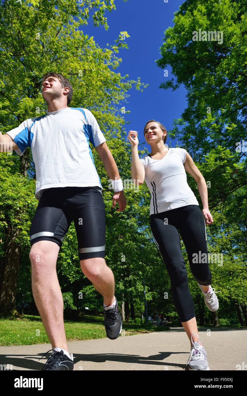 Young couple jogging in park at morning. Health and fitness Stock Photo ...