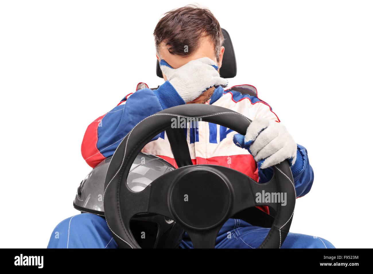 Disappointed car racer sitting on a car seat and looking down isolated ...