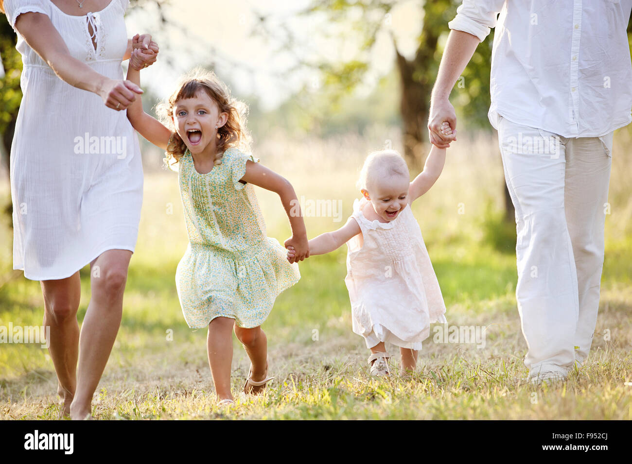 Happy young family spending time outdoor on a summer day Stock Photo ...