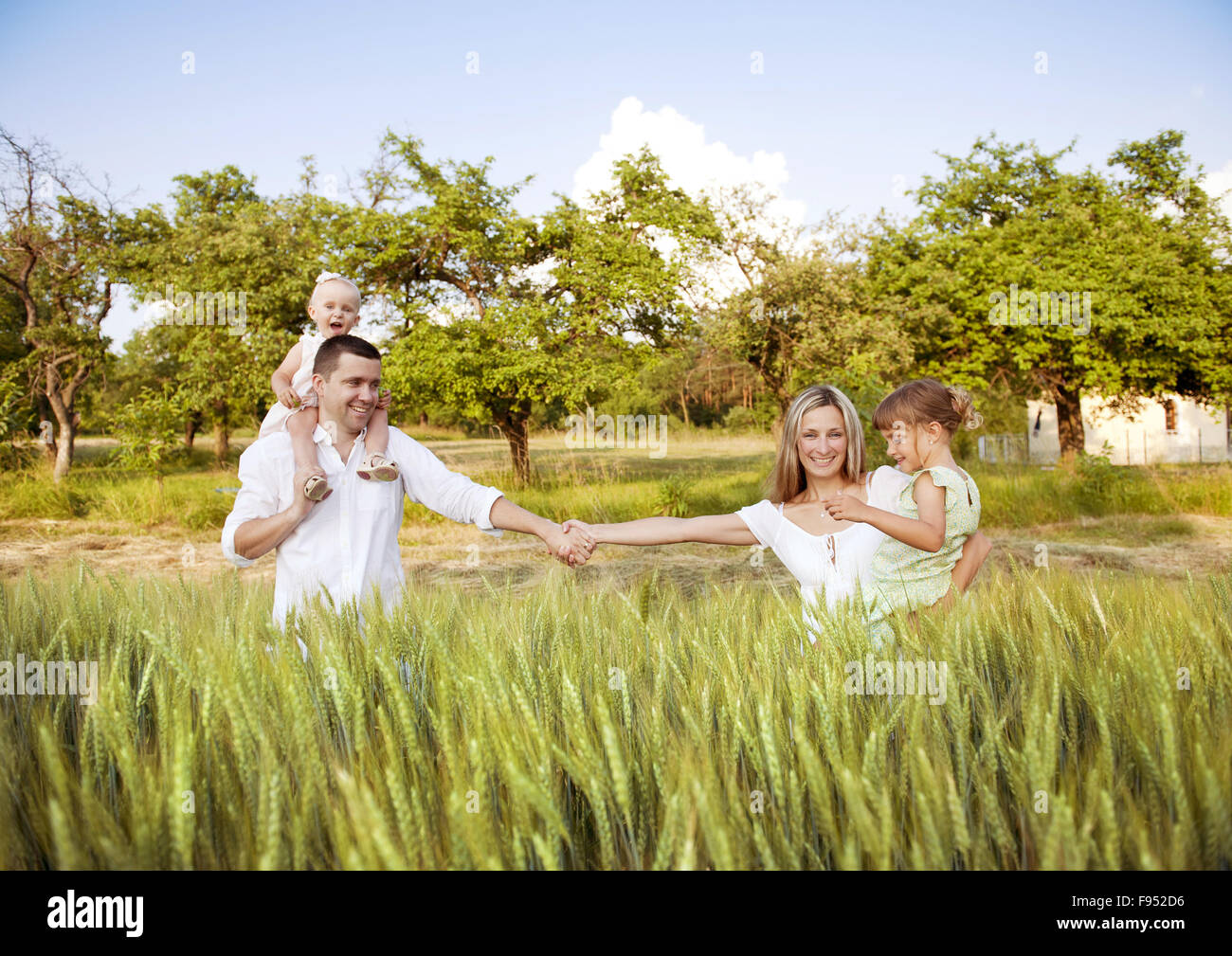 Happy young family spending time outdoor on a summer day Stock Photo ...