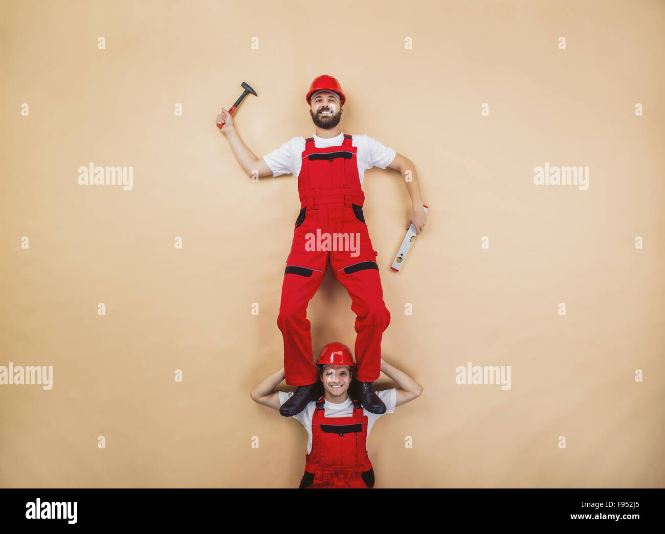 Construction workers have an accident. Funny studio poses Stock Photo ...