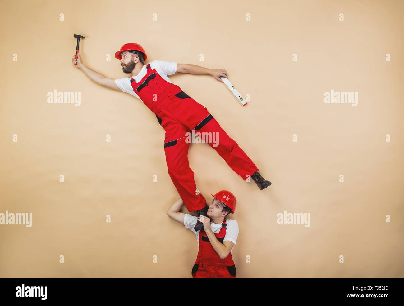 Construction workers have an accident. Funny studio poses Stock Photo ...