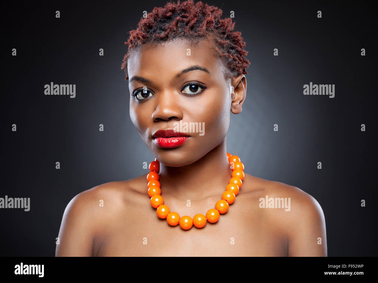 Black beauty with short spiky red hair Stock Photo - Alamy