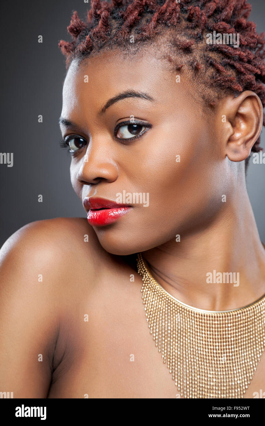 Black beauty with short spiky red hair Stock Photo - Alamy