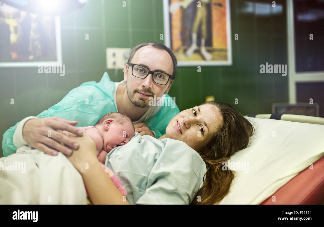 Beautiful baby girl few minutes after the birth with her mother and ...