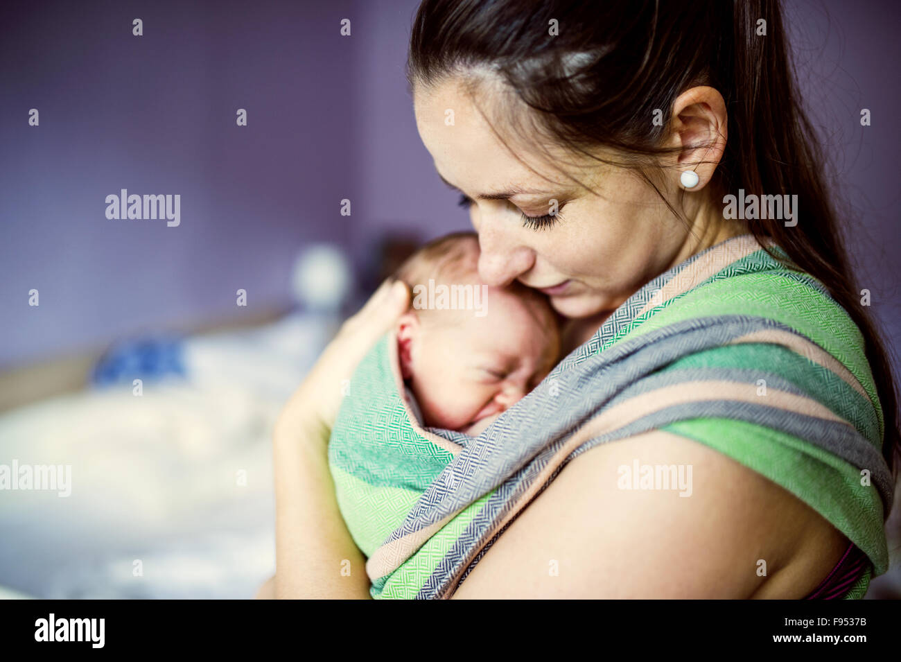 Newborn baby hold by mother in the baby wrap carrier Stock Photo - Alamy