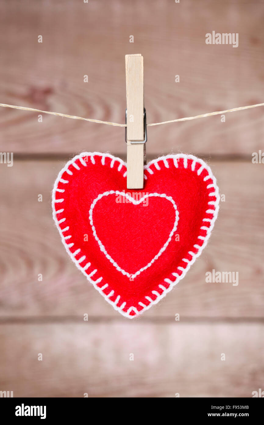 A clothesline with a cute Valentine's Day heart decoration on a rustic ...