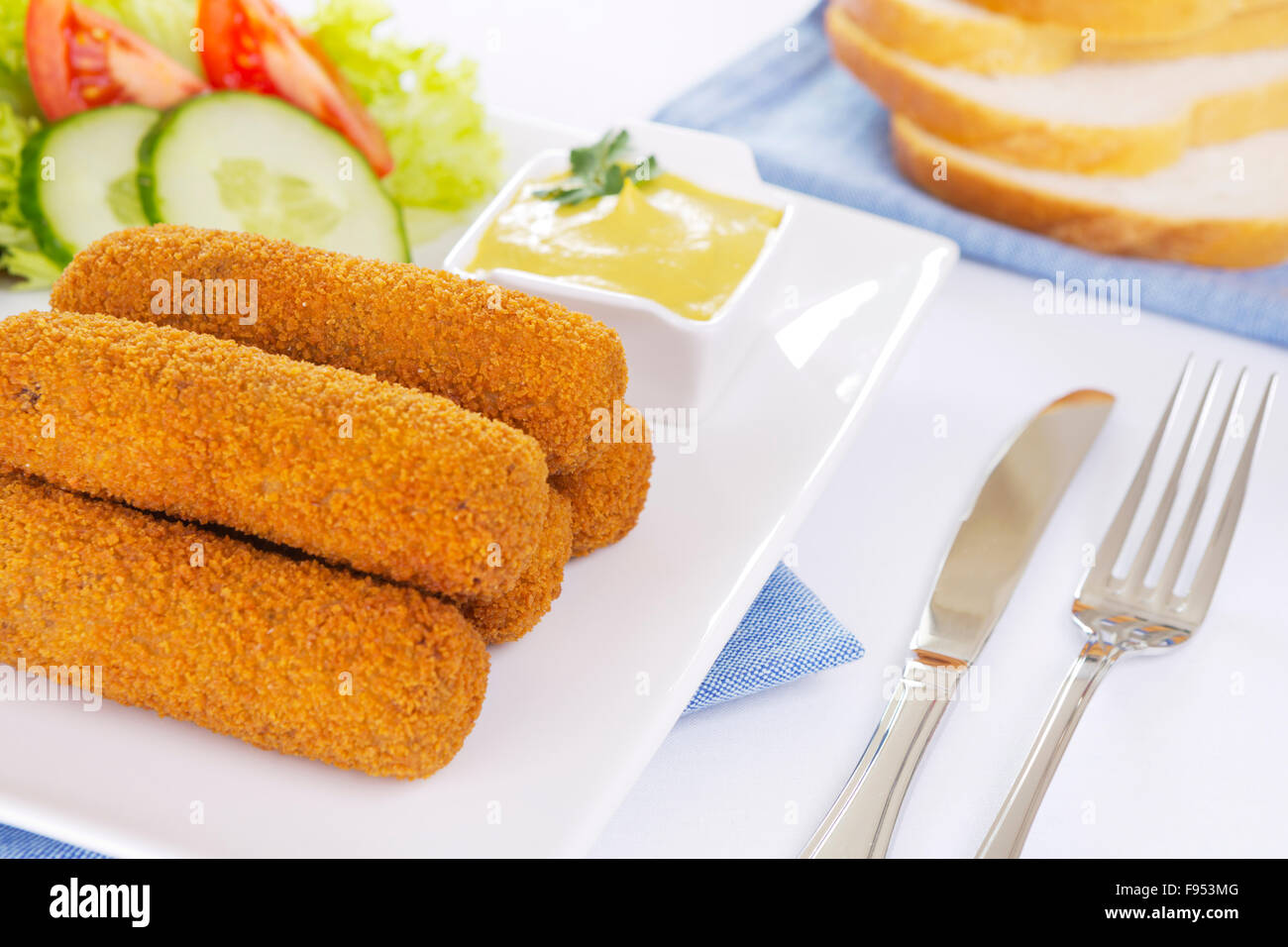 Deep fried Dutch meat croquettes ('kroket') and bread on a plate Stock ...