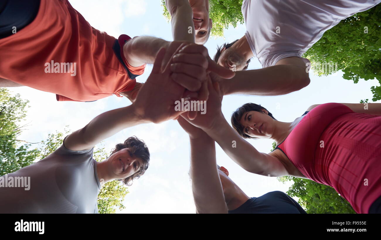 jogging people group, friends have fun, hug and stack hands together ...
