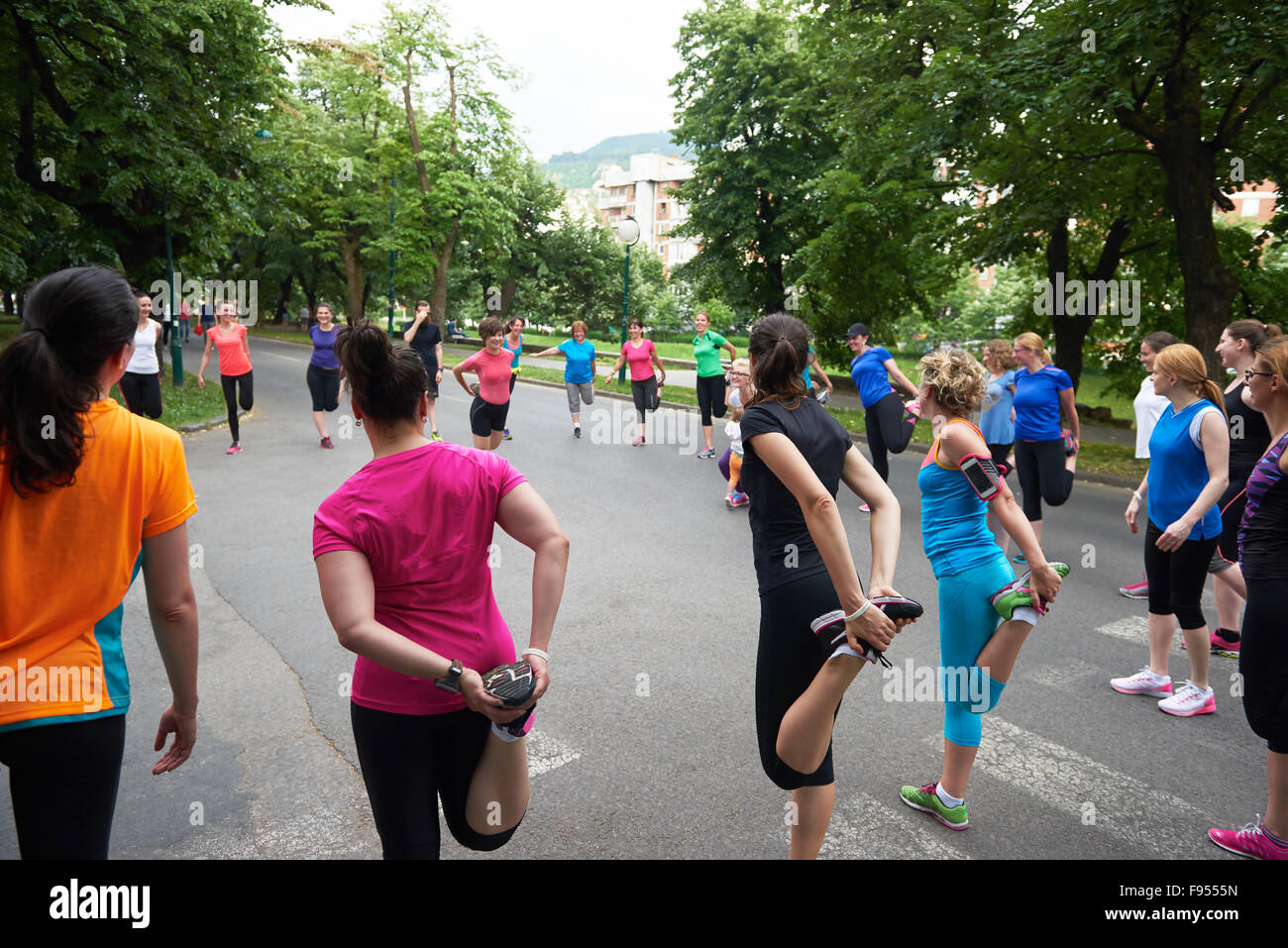 jogging people group stretching in park before training Stock Photo - Alamy