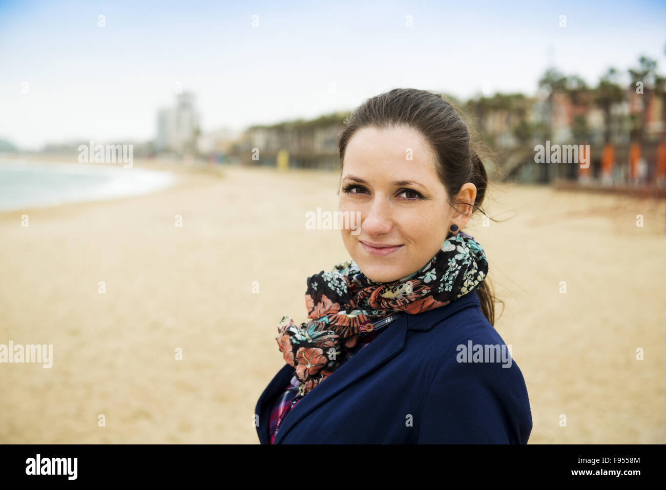 Portrait of pretty young traveler on the beach on a cold day Stock ...