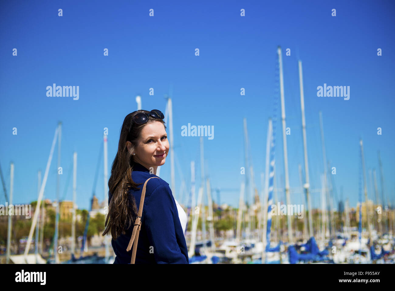 Happy young female tourist at the boat harbor Stock Photo - Alamy