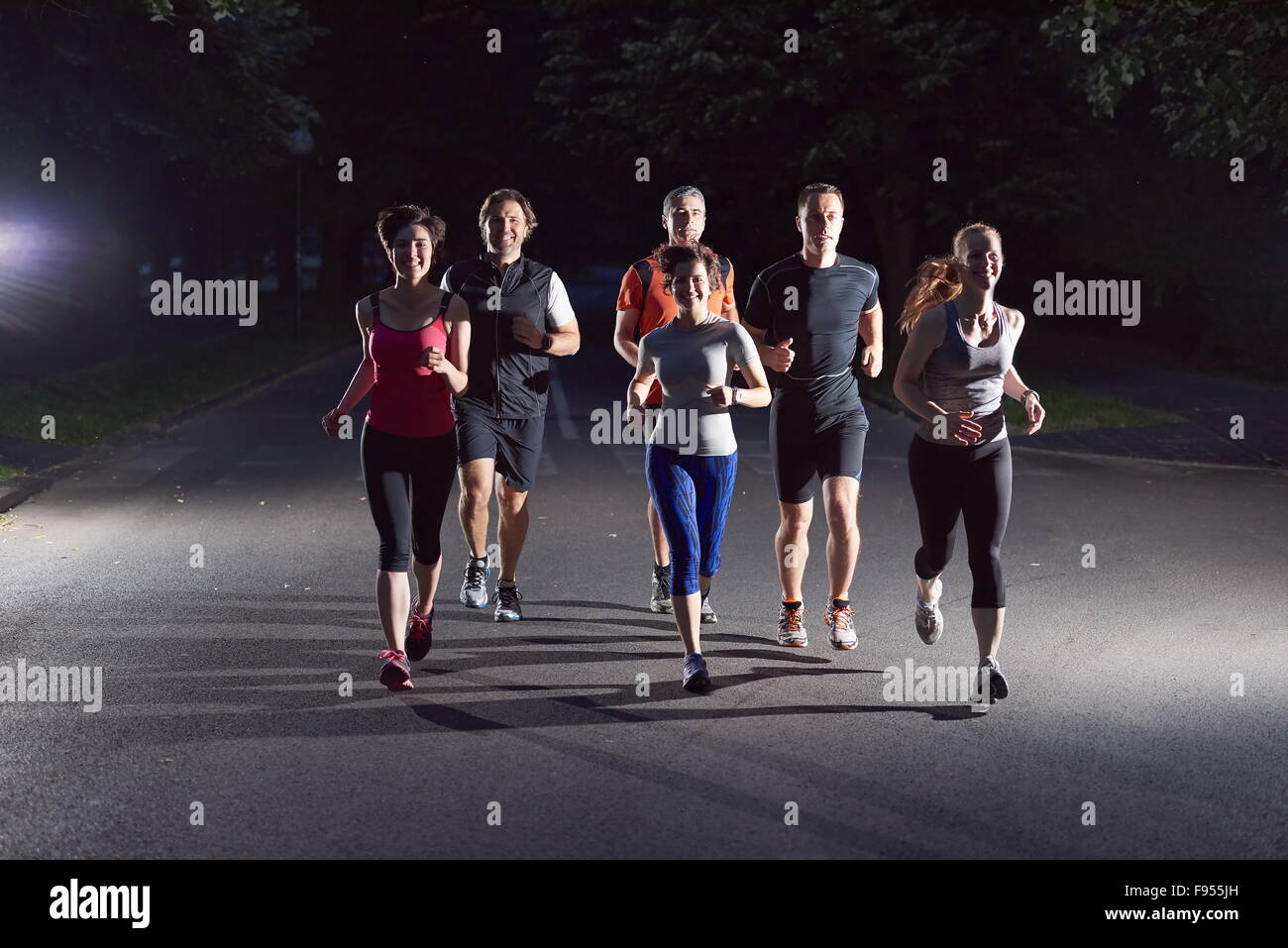 people group jogging at night, runners team on early morning training ...