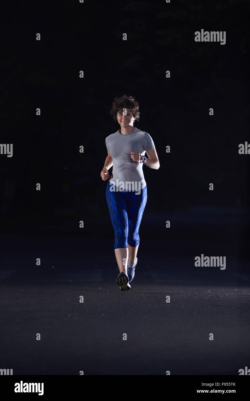 Woman jogging in the dark hi-res stock photography and images - Alamy