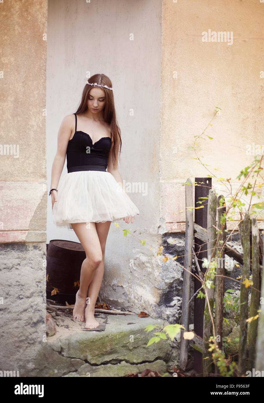 Outdoor portrait of beautiful girl posing by the old house Stock Photo ...