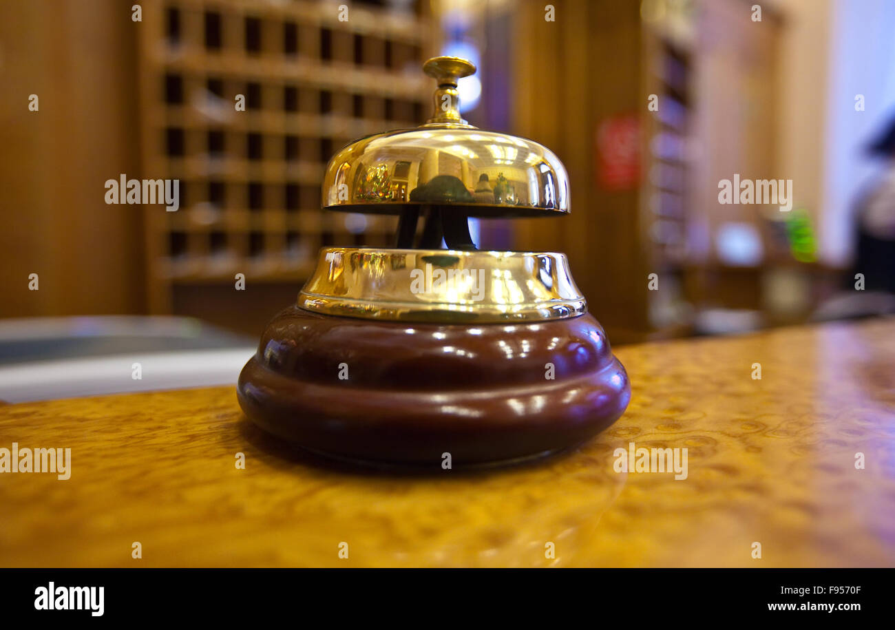 Golden bell on reception desk in hotel Stock Photo - Alamy