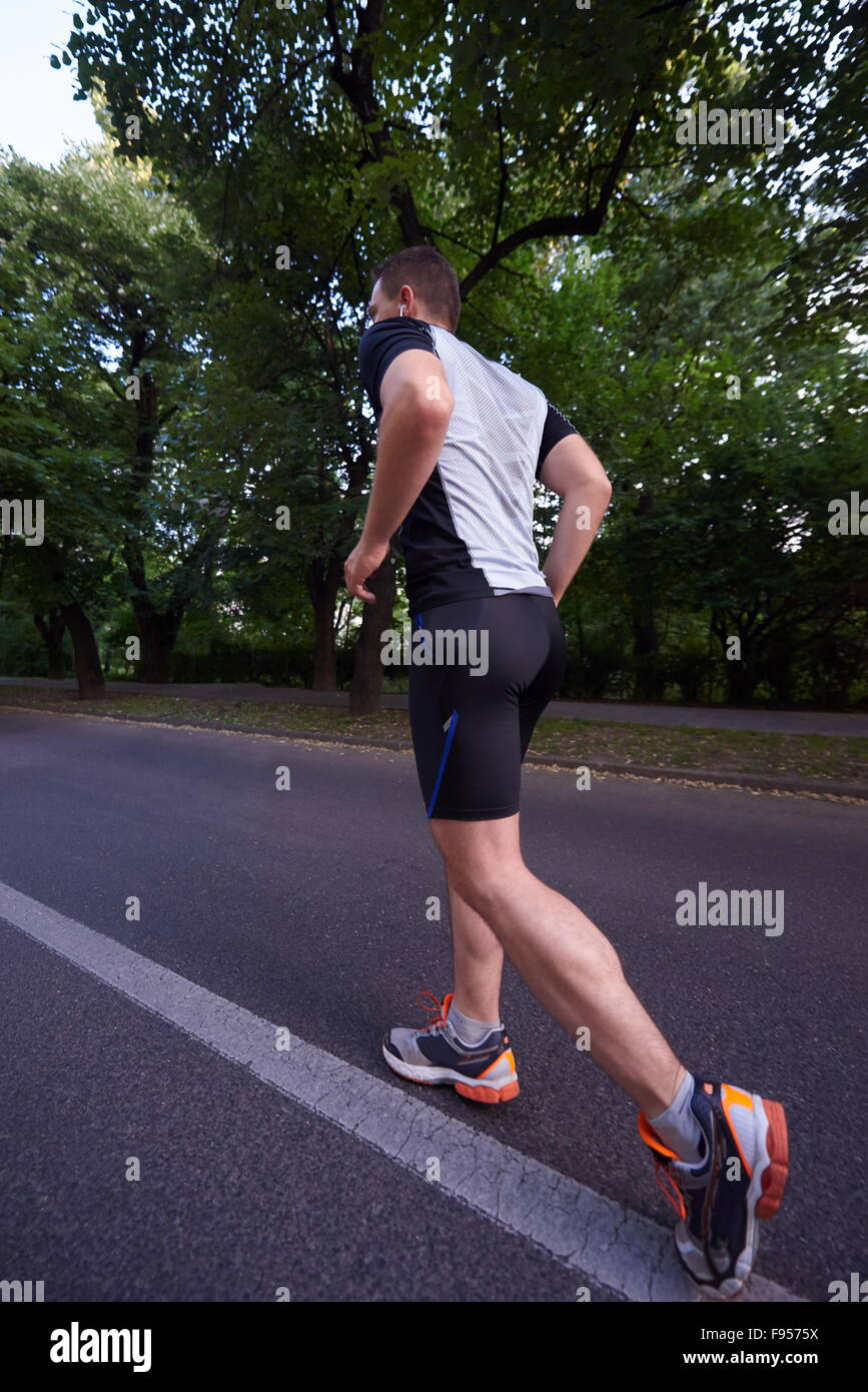 healthy athlete man jogging at morning on empty roat in the city Stock ...