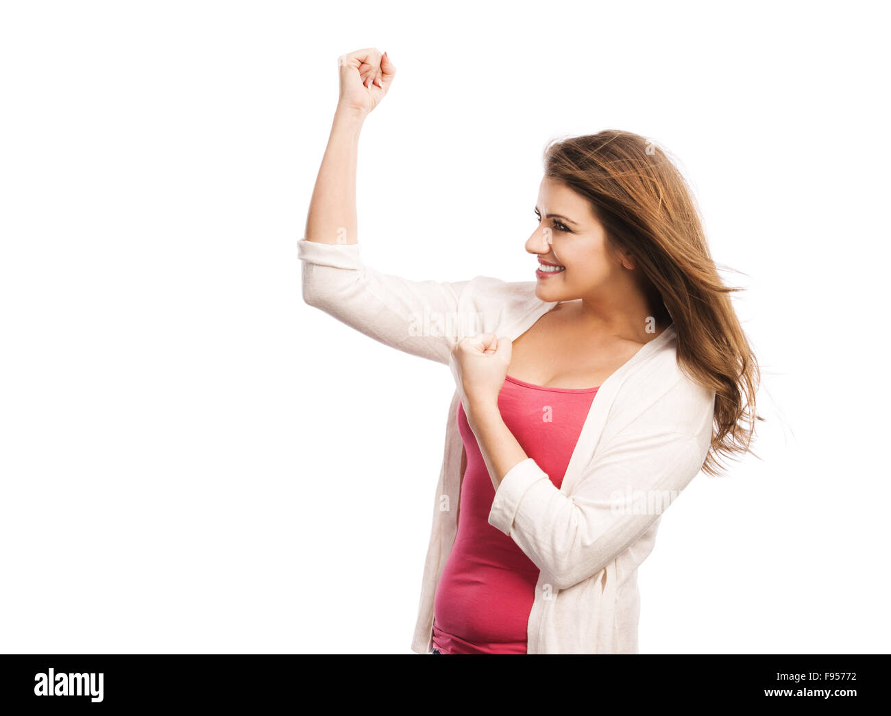 Happy young woman saying yes and gesturing while isolated on white ...