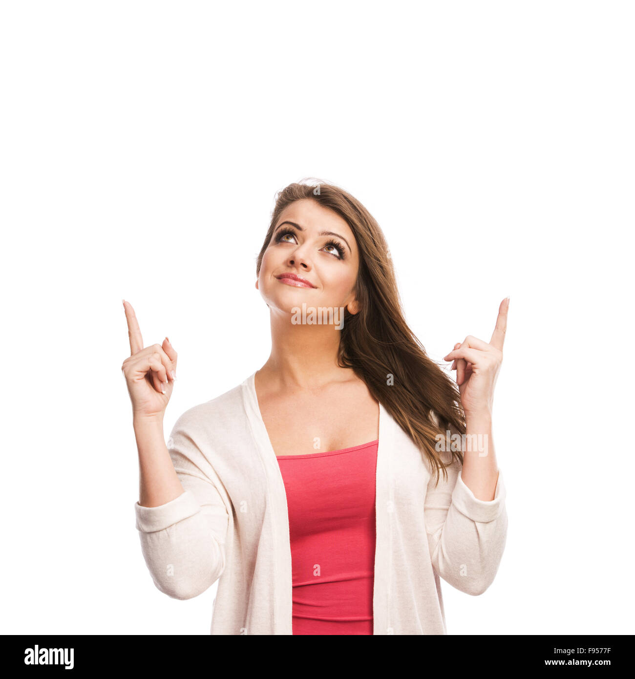 Beautiful young woman pointing upwards, isolated over a white ...