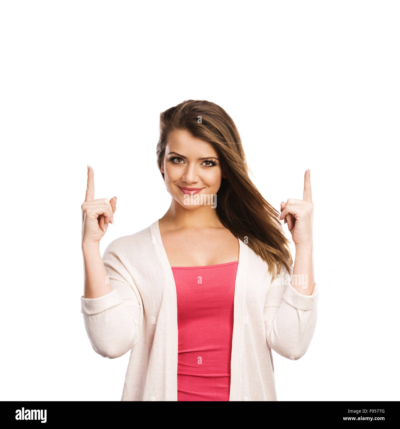 Beautiful young woman pointing upwards, isolated over a white ...