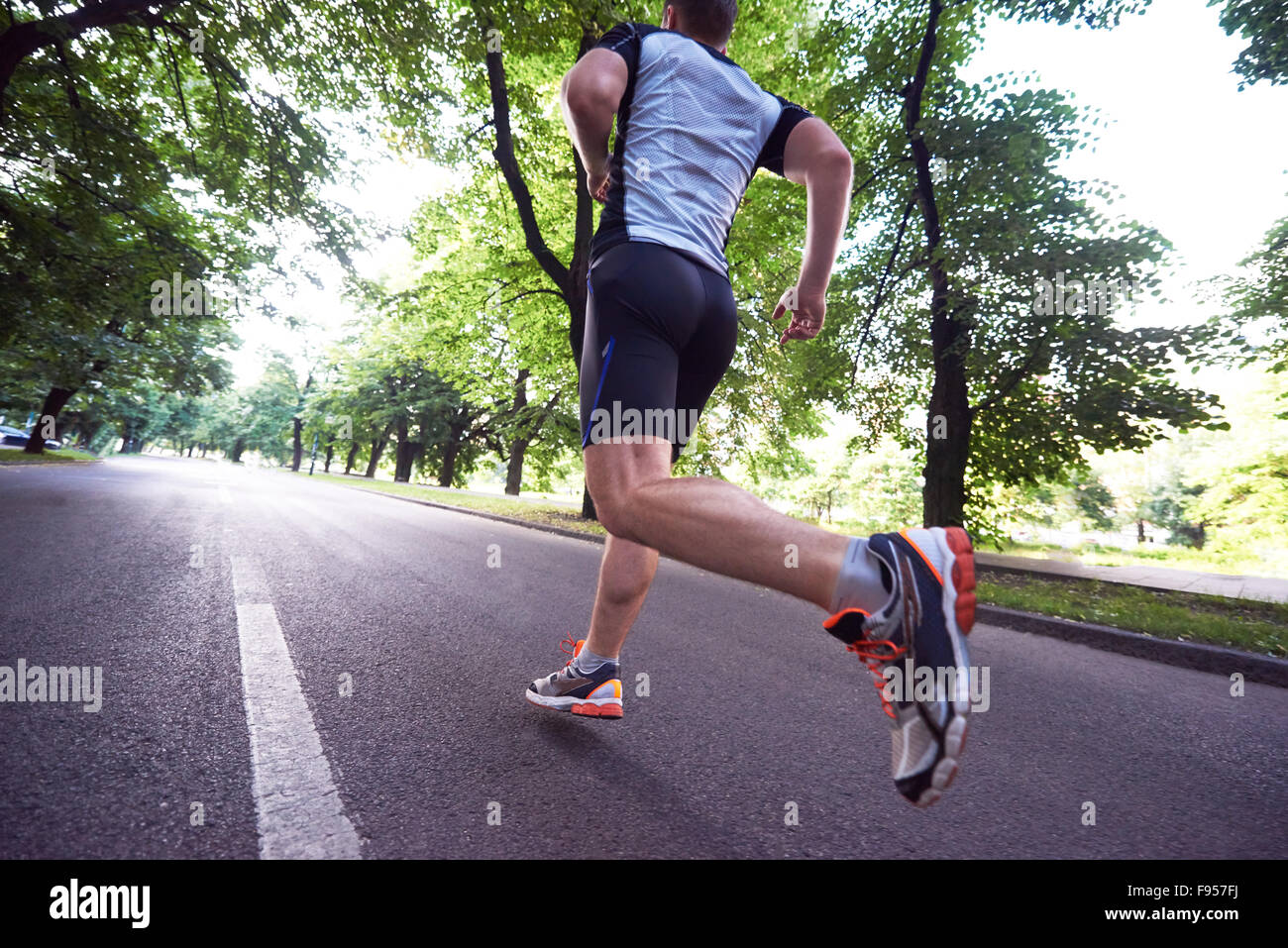 healthy athlete man jogging at morning on empty roat in the city Stock ...
