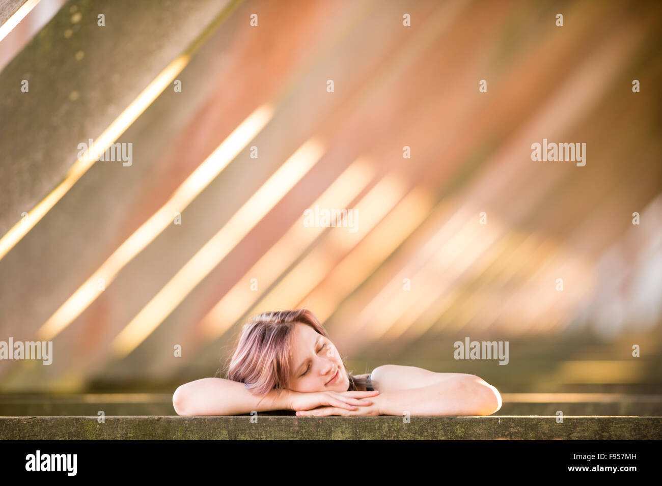 Daydreaming - a young woman girl with her eyes closed resting her head ...