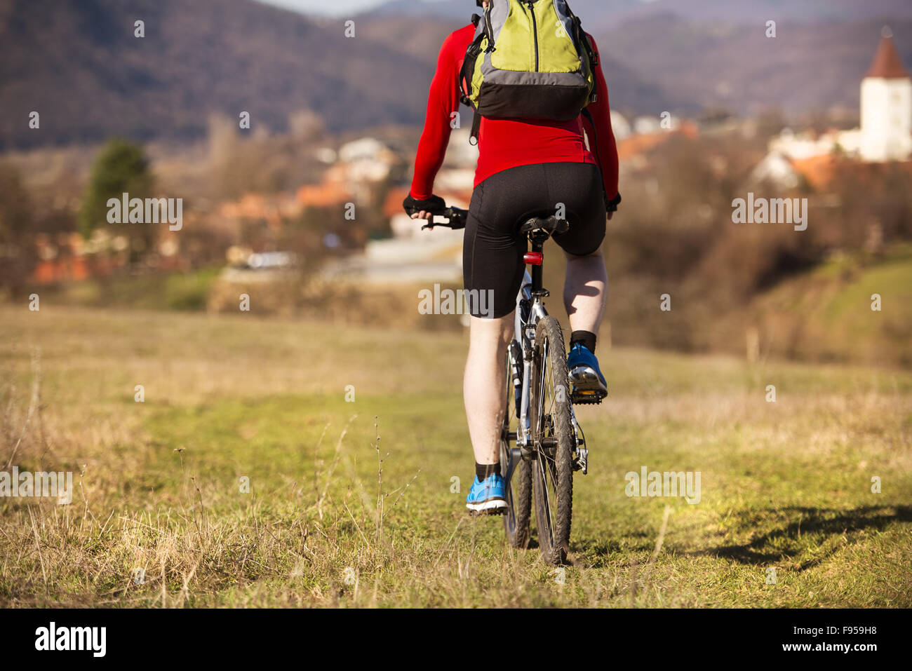 Rear view of cyclist man riding mountain bike on outdoor trail in ...