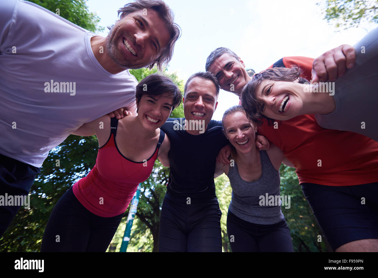 jogging people group, friends have fun, hug and stack hands together ...