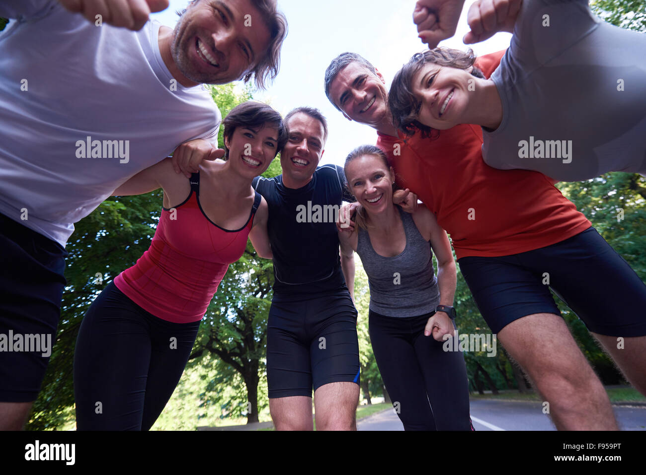 jogging people group, friends have fun, hug and stack hands together ...