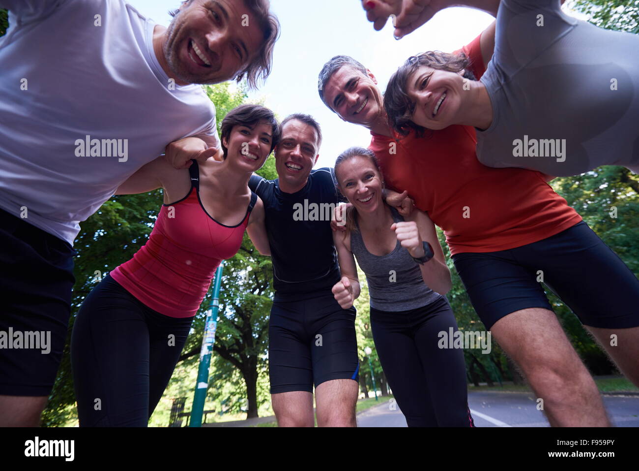 jogging people group, friends have fun, hug and stack hands together ...