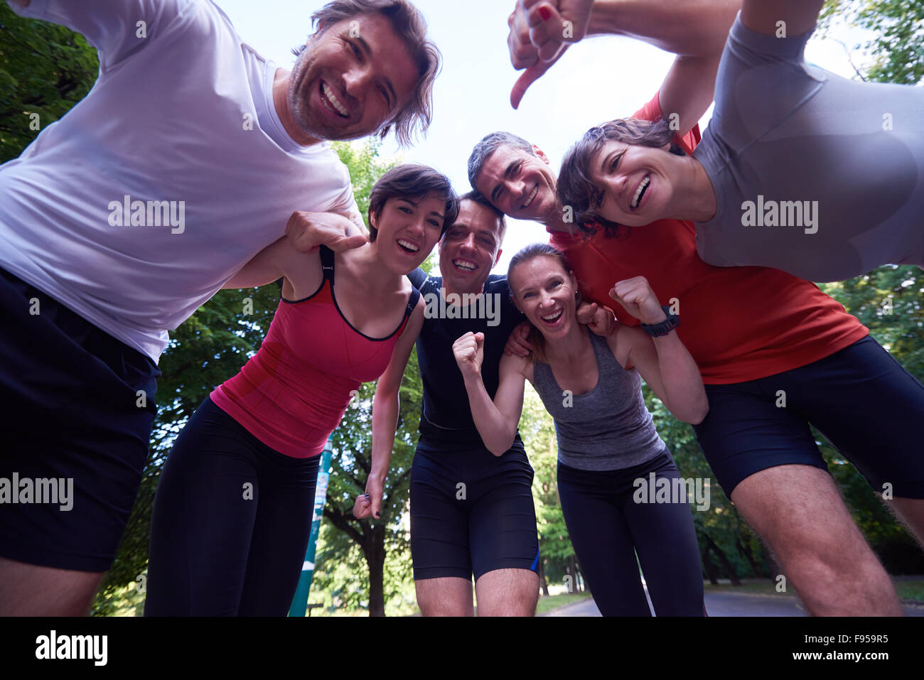 jogging people group, friends have fun, hug and stack hands together ...