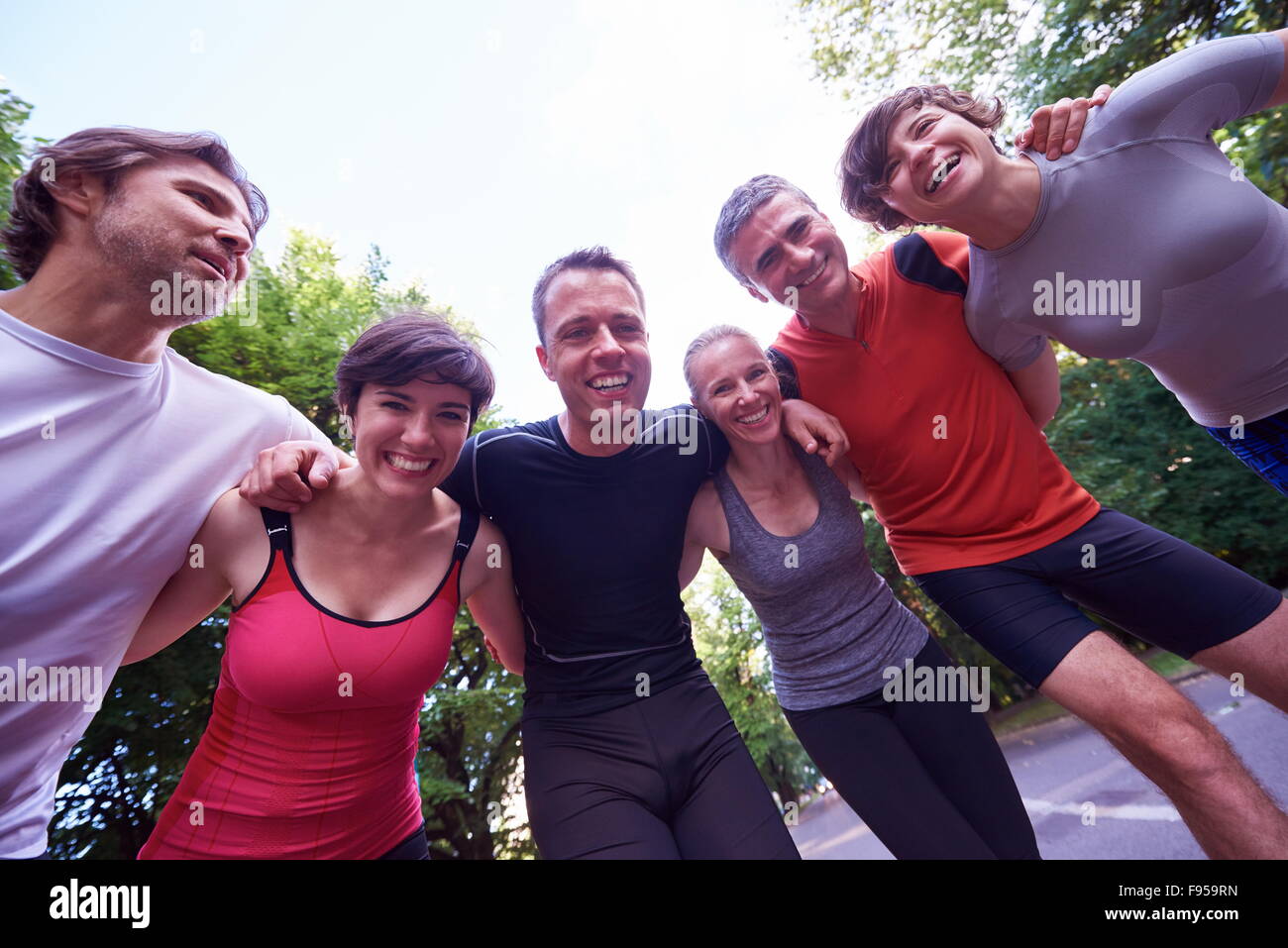 jogging people group, friends have fun, hug and stack hands together ...