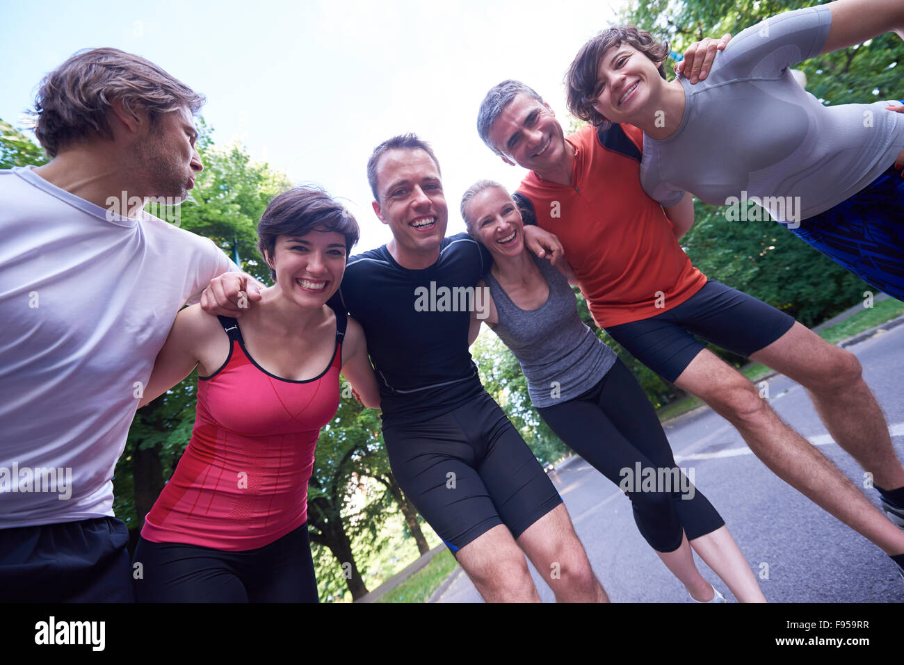 jogging people group, friends have fun, hug and stack hands together ...