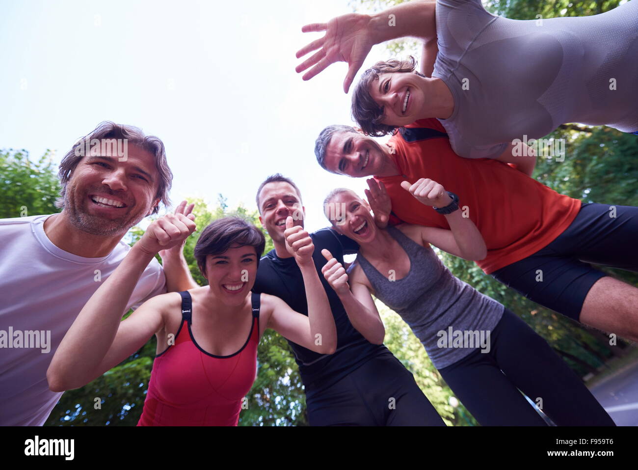 jogging people group, friends have fun, hug and stack hands together ...