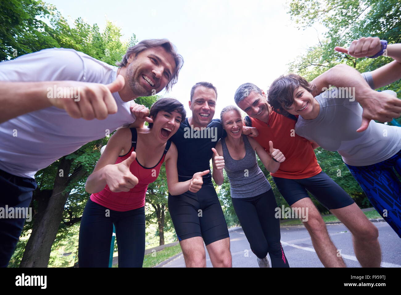 jogging people group, friends have fun, hug and stack hands together ...