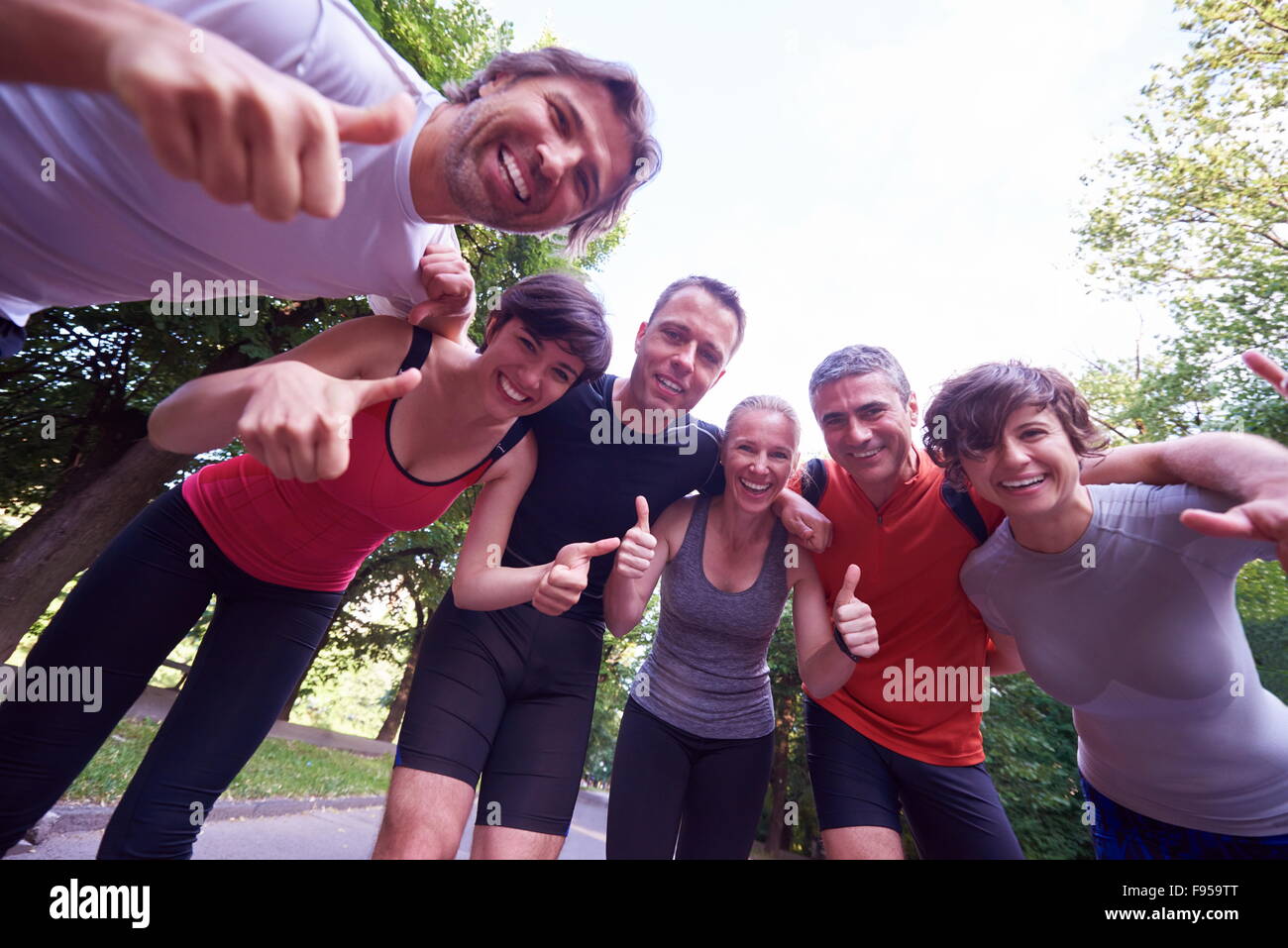 jogging people group, friends have fun, hug and stack hands together ...