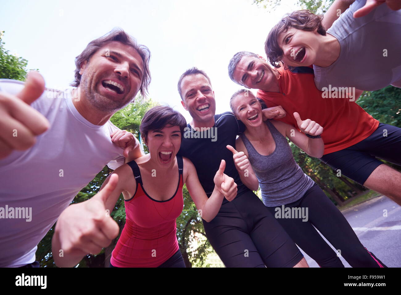 jogging people group, friends have fun, hug and stack hands together ...