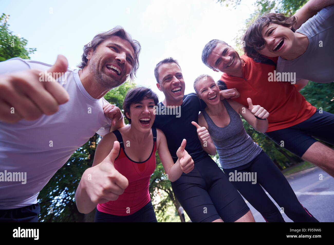 jogging people group, friends have fun, hug and stack hands together ...