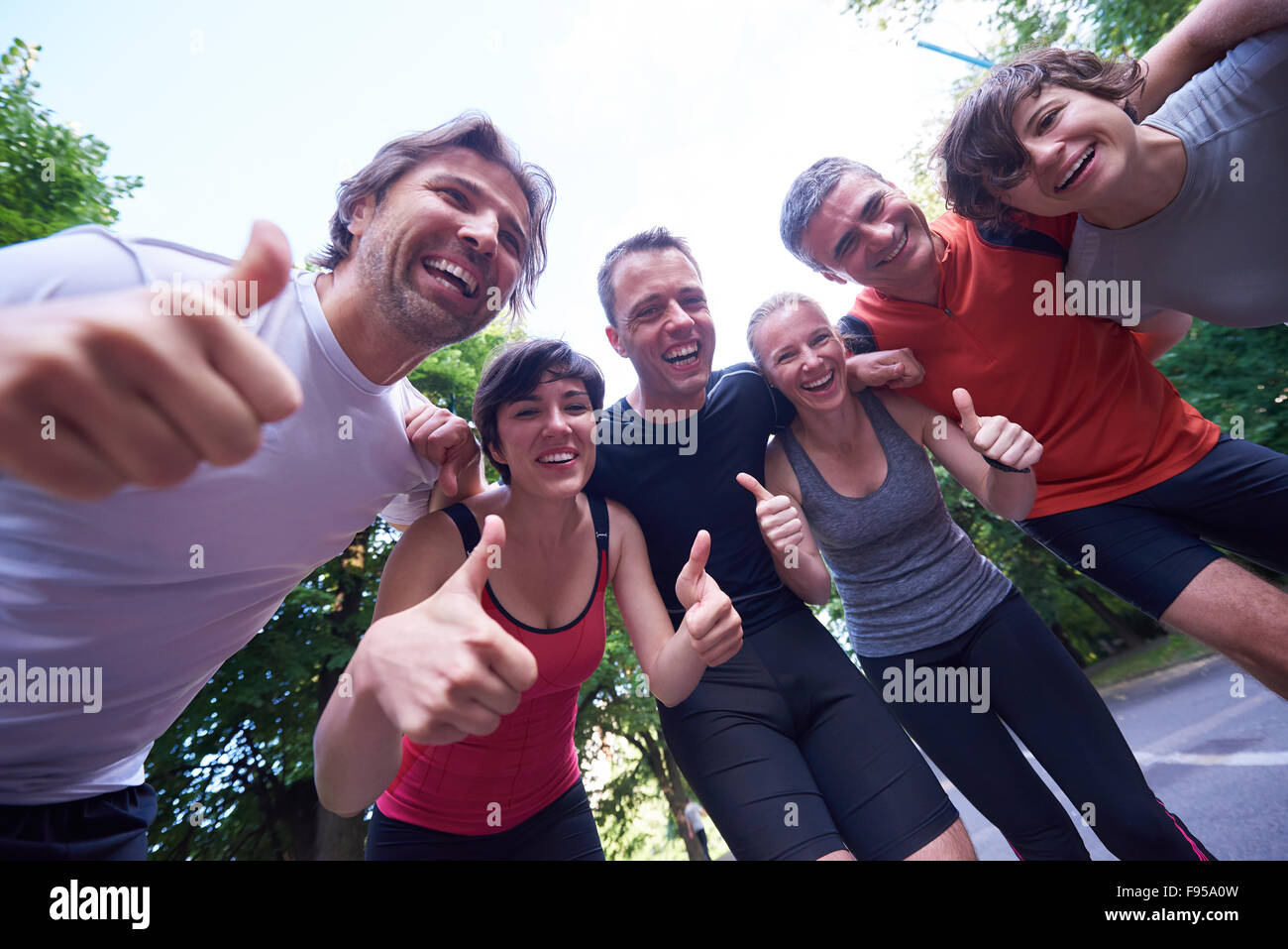 jogging people group, friends have fun, hug and stack hands together ...