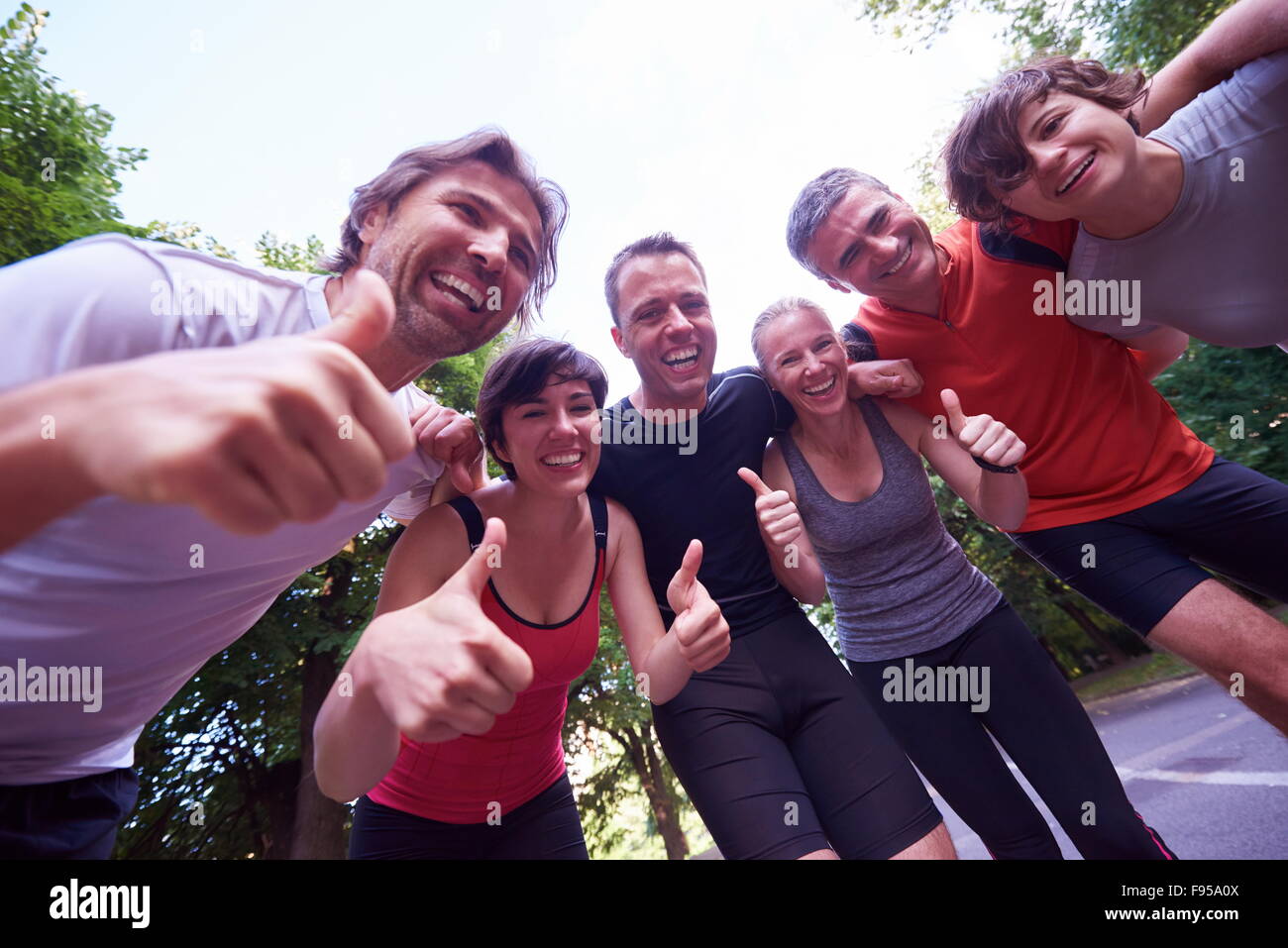 jogging people group, friends have fun, hug and stack hands together ...