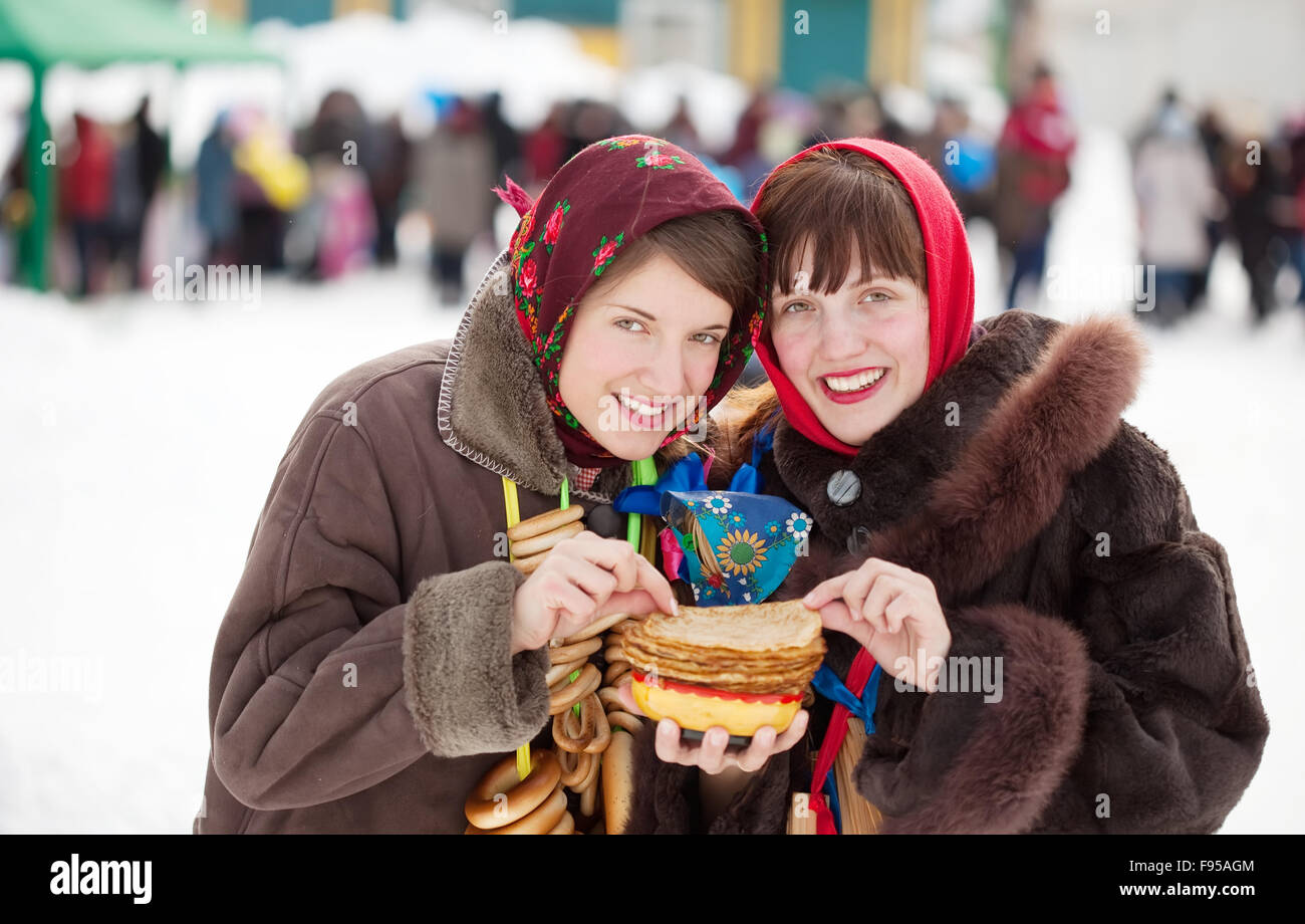 Women in traditional clothes eating pancake during Pancake Week Stock ...