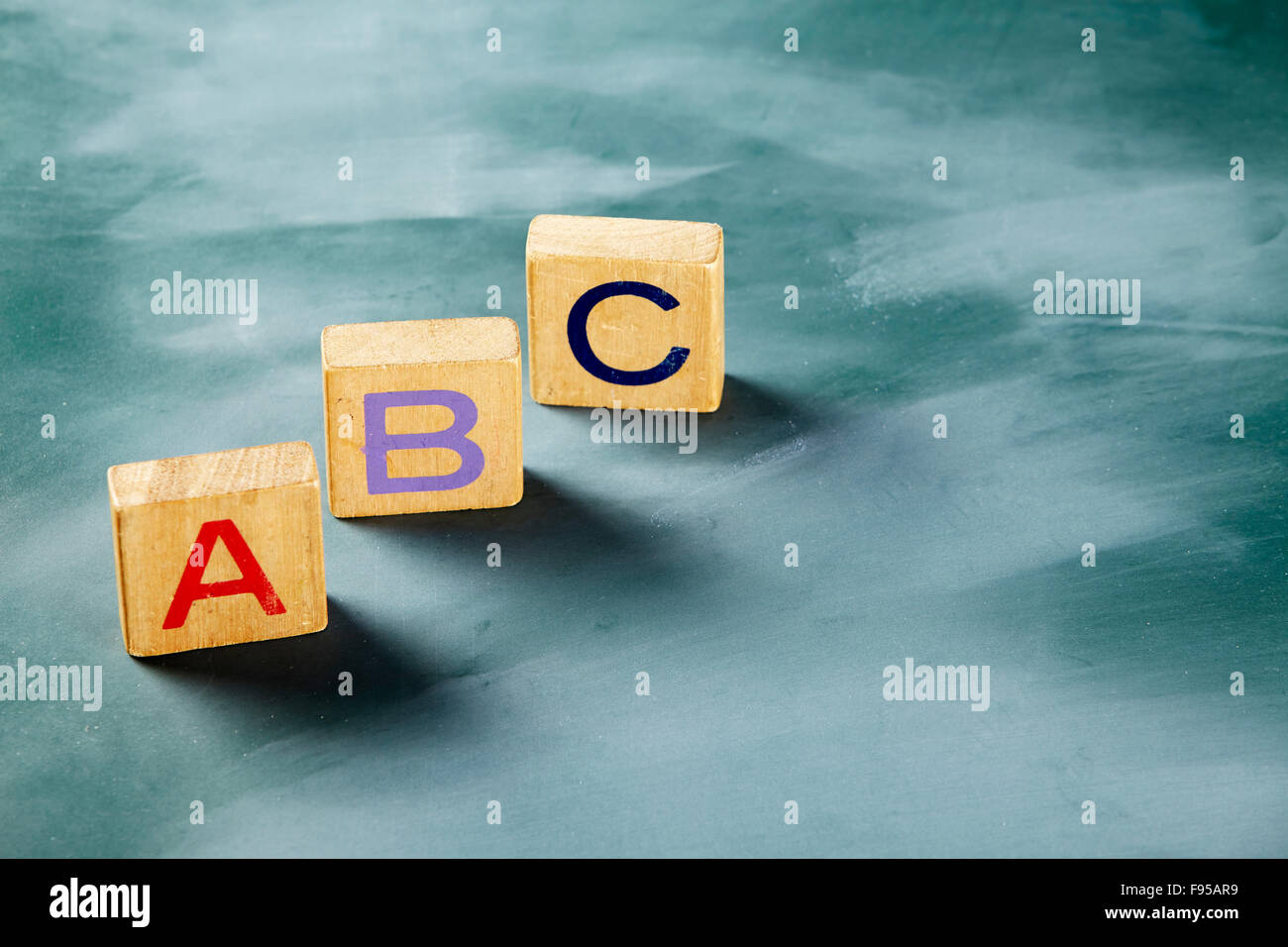 wooden square block abc on the blackboard Stock Photo - Alamy