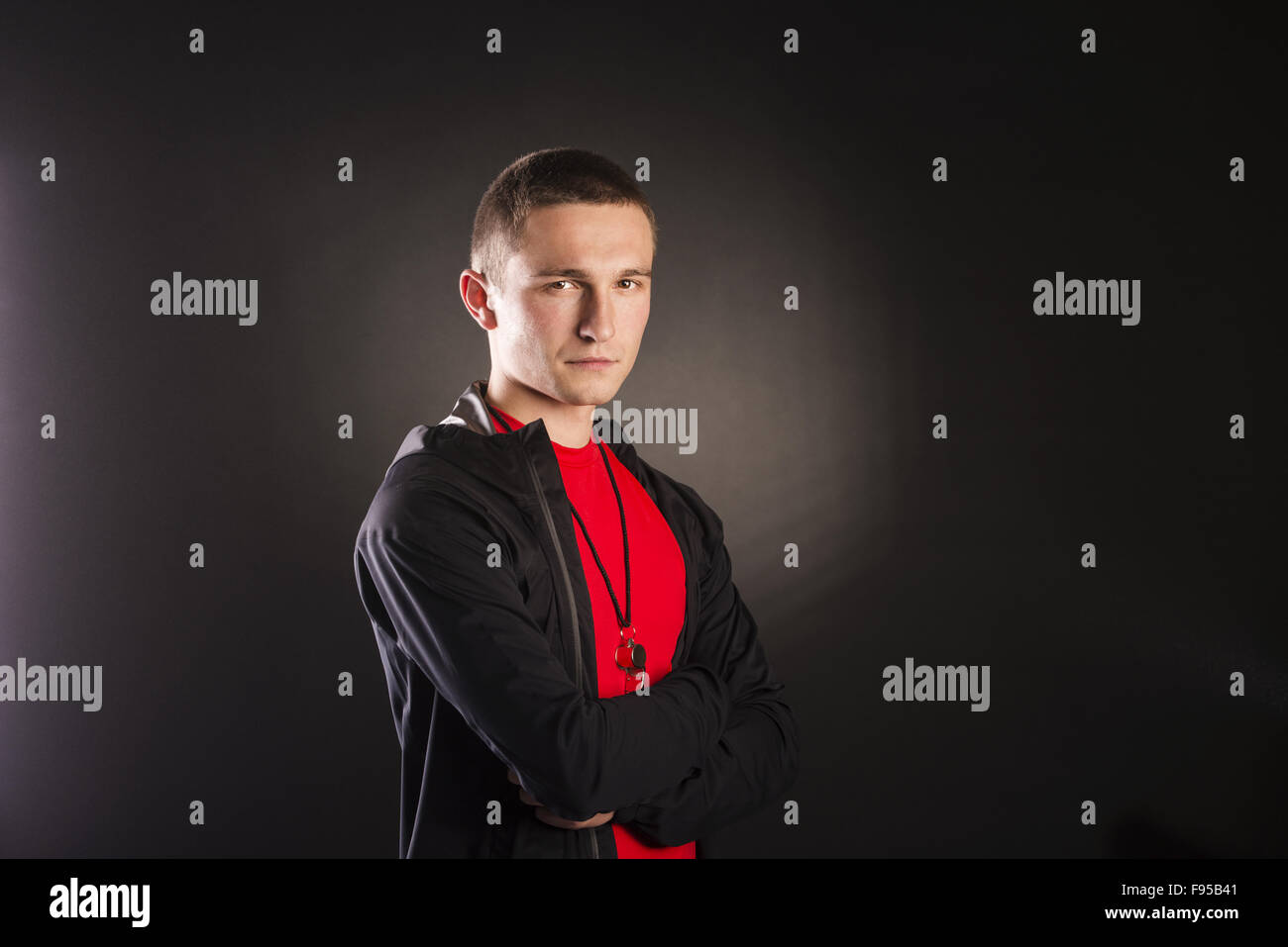 Professional fitness coach isolated on black background Stock Photo - Alamy